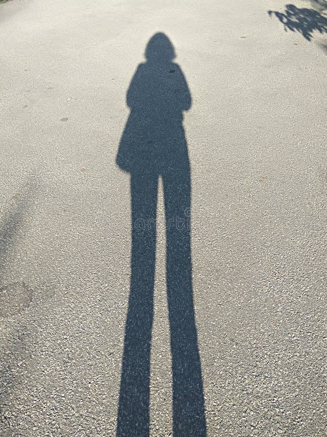Shadow of a Tall Girl on an Asphalt Road. Stock Image - Image of blur ...