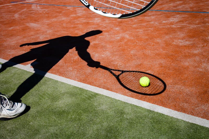 Shadow Of A Tennis Player In Action Stock Image - Image: 25109961