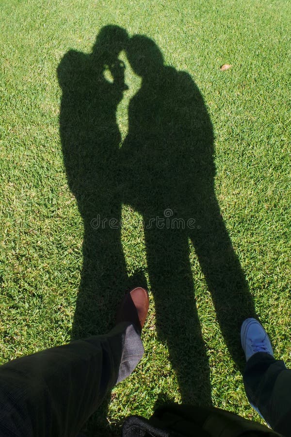 Shadow of Two Men on Green Grass in the Morning Stock Photo - Image of ...