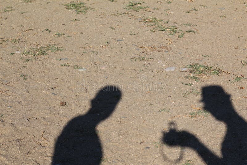 Shadow of Two Men on the Sand at the Beach Stock Image - Image of ...