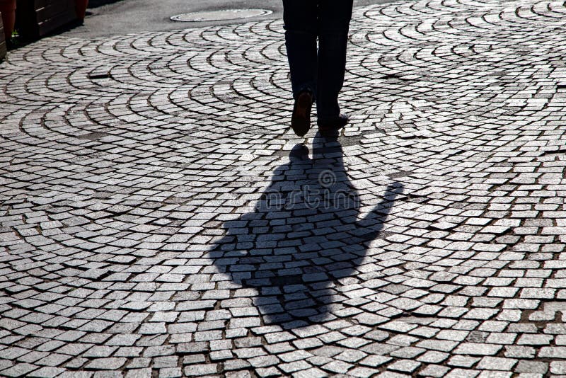 Shadow of a Walking Person on Historic Cobblestone Stock Image - Image ...