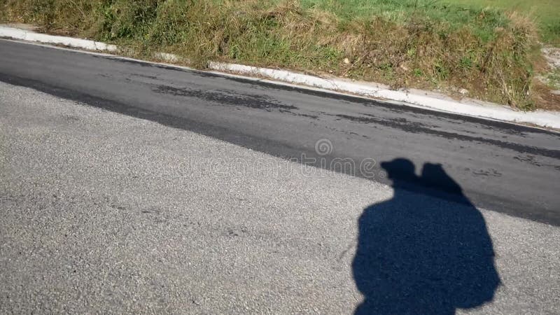 The Shadow of a Walking Pilgrim on Asphalt Stock Video - Video of ...