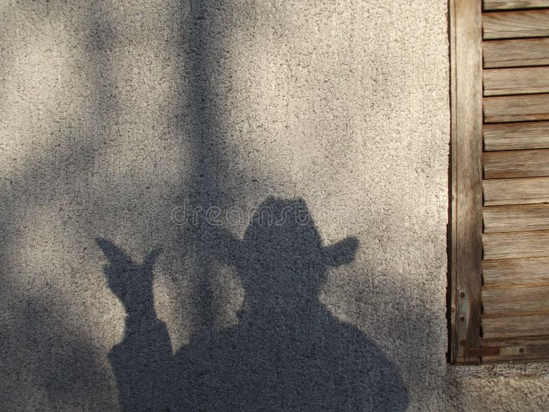 Cowboy shadow on rock stock photo. Image of wall, shadow - 23103674
