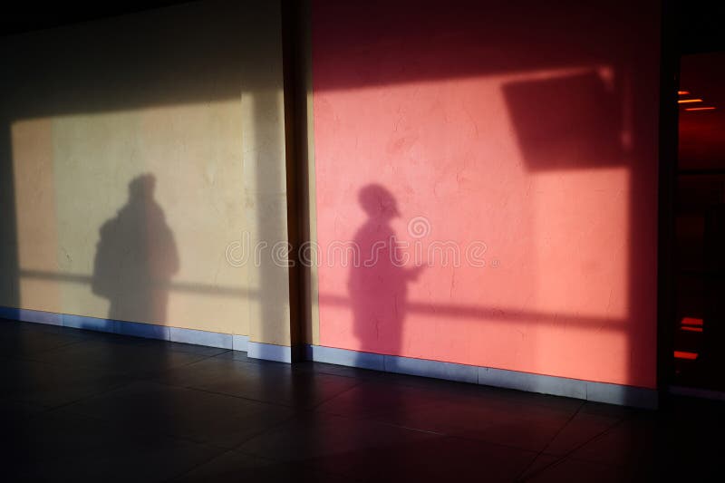 A Shadow on the Wall, a Man Watching the Departures Screen. Silhouettes ...