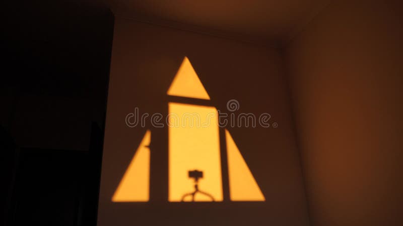 Shadow on the Wall of the Room from a Mobile Phone on a Tripod in the ...