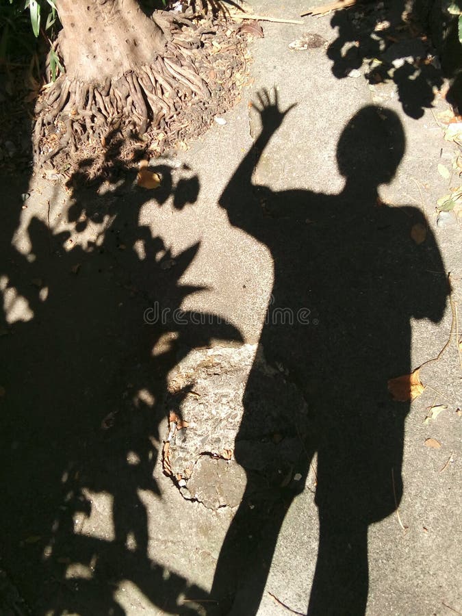 Shadow of a Man Waving from a Bridge Stock Photo - Image of asphalt ...