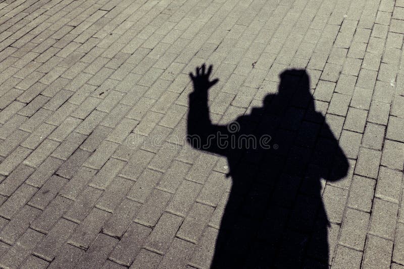 Shadow of a Waving Person Cast on the Tiles of the Ground Stock Photo ...
