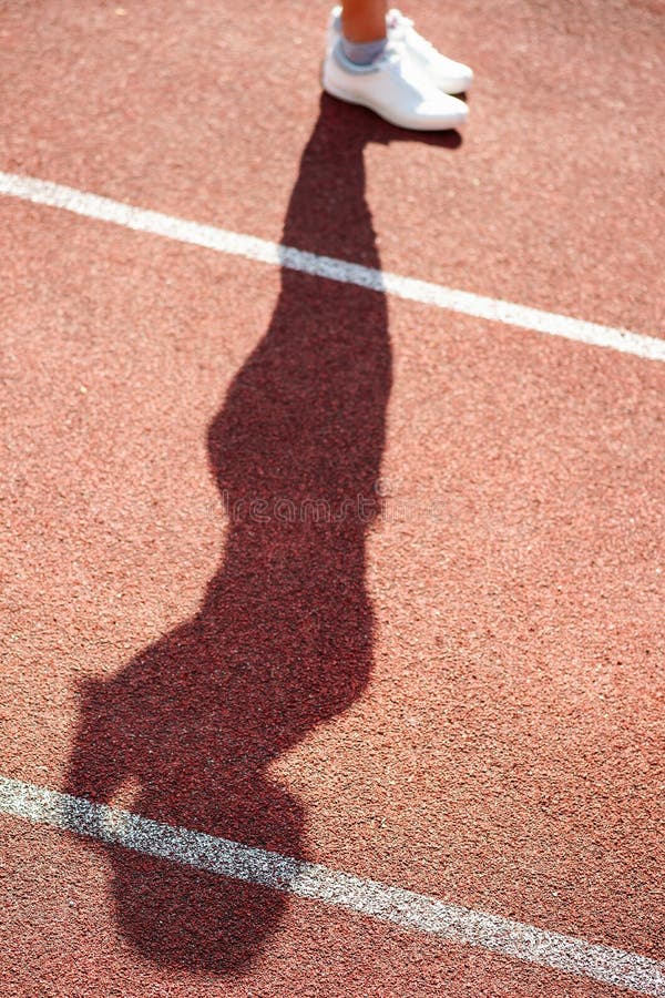 Shadow of Woman Athlete on Running Track Stock Image - Image of striped ...