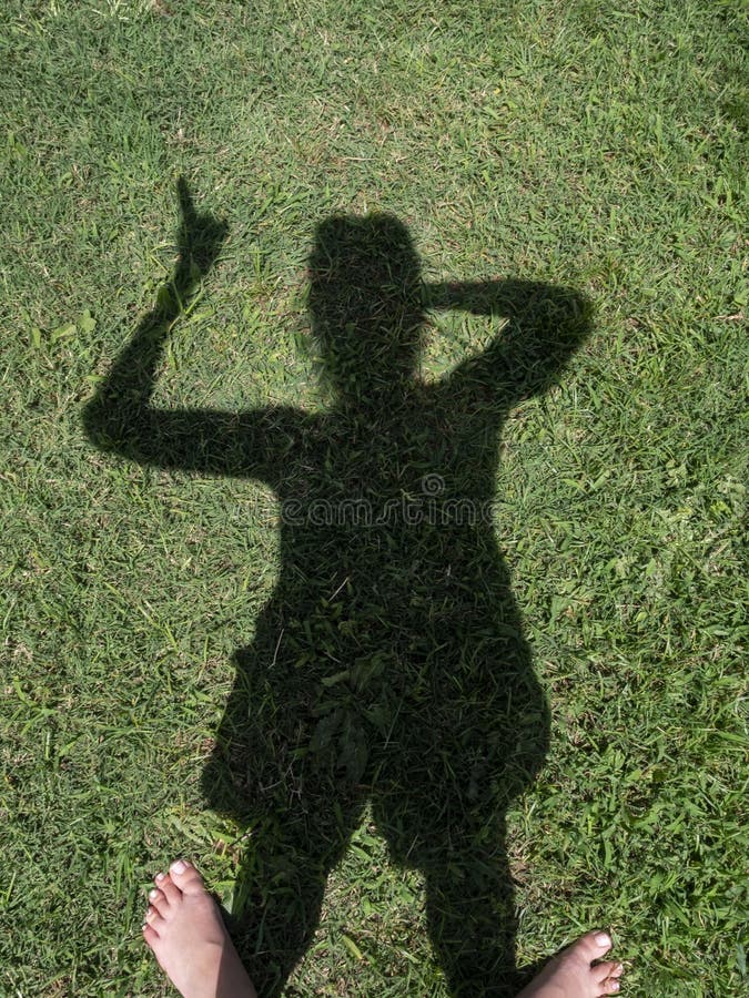 Shadow of a Woman with Reflection on the Grass Stock Image - Image of ...