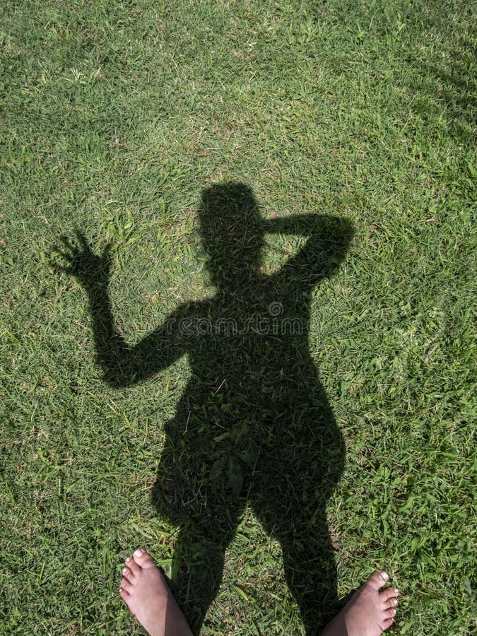 Shadow of a Woman with Reflection on the Grass Stock Photo - Image of ...