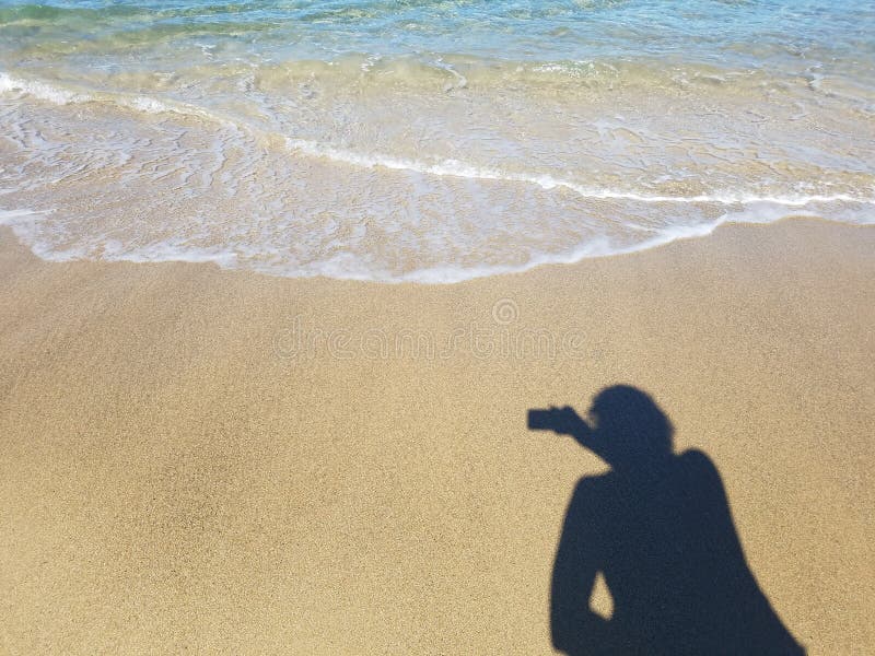 Shadow of Woman Taking Picture in Sand with Water Stock Image - Image ...
