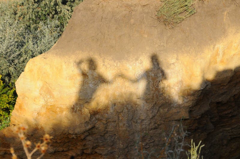 Shadow on Yellow Clay of Two People Holding Hands Stock Image - Image ...