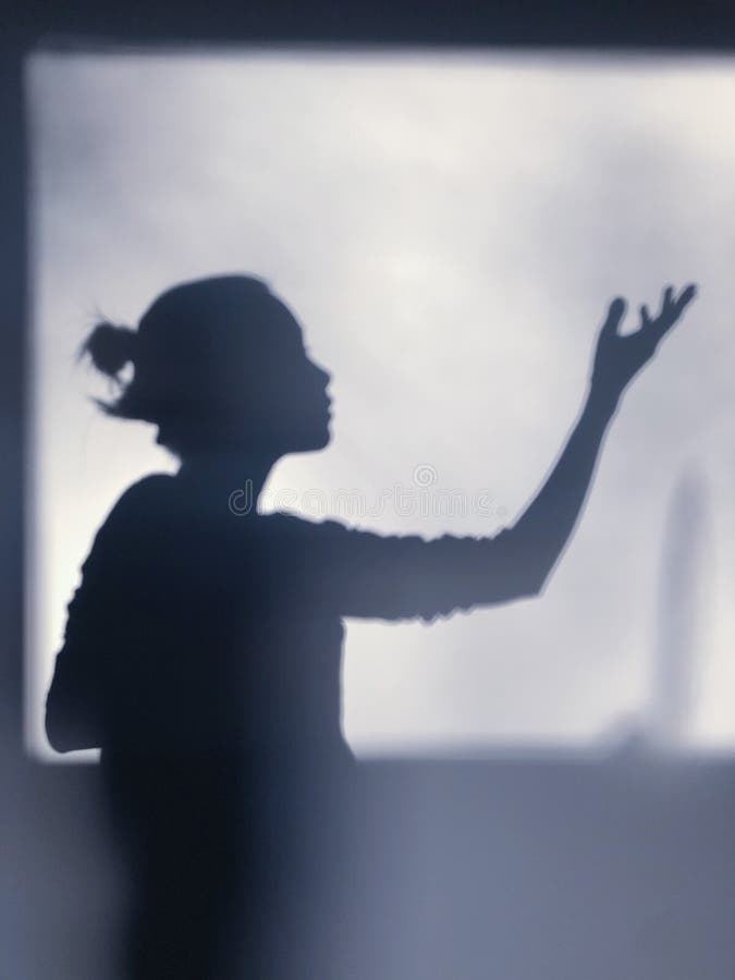The Shadow of a Young Woman Shot Against a White Wall in Profile Stock ...