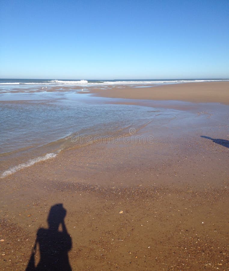Shadows on the beach stock image. Image of shore, woman - 53615893