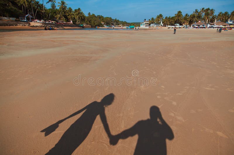 Shadows on the beach stock image. Image of companionship - 54423579