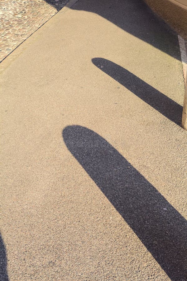 Shadows Casted by Stone Pillars on a Pavement at Sunset Stock Image ...