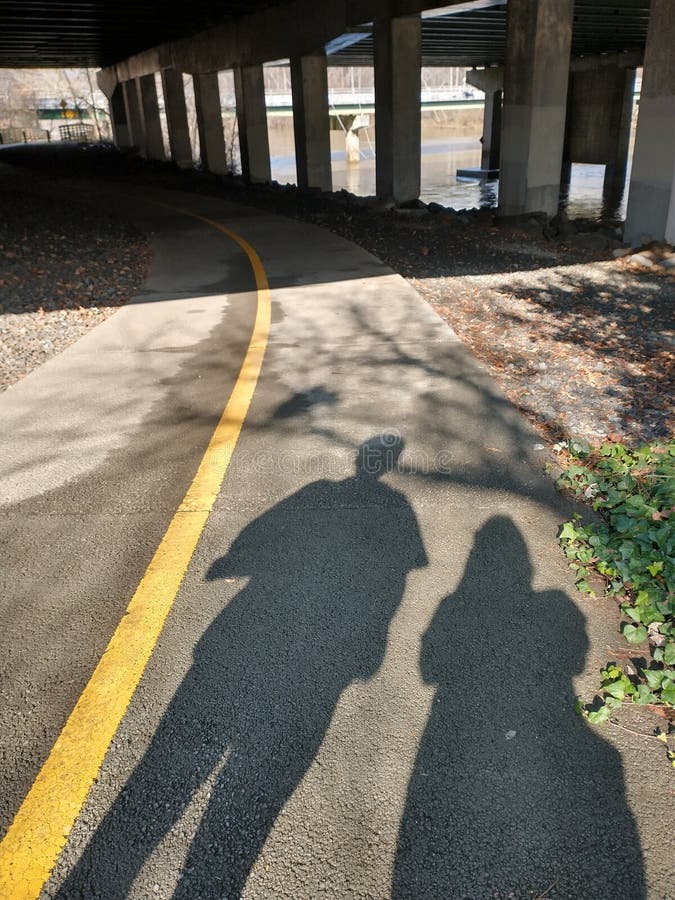 Shadows of a Couple Walking Under a Bridge Stock Photo - Image of tarmac, pedestrian: 267787558