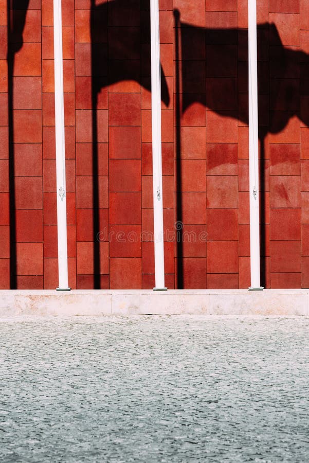 Shadows of Flagpoles on the Red Wall of Stone Building Stock Photo ...