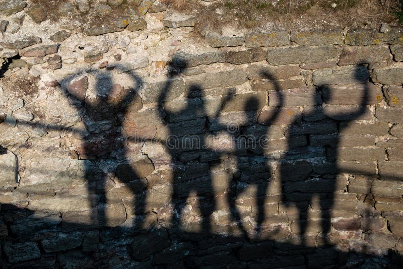 Shadows from Four People on the Wall Stock Photo - Image of black, loom ...