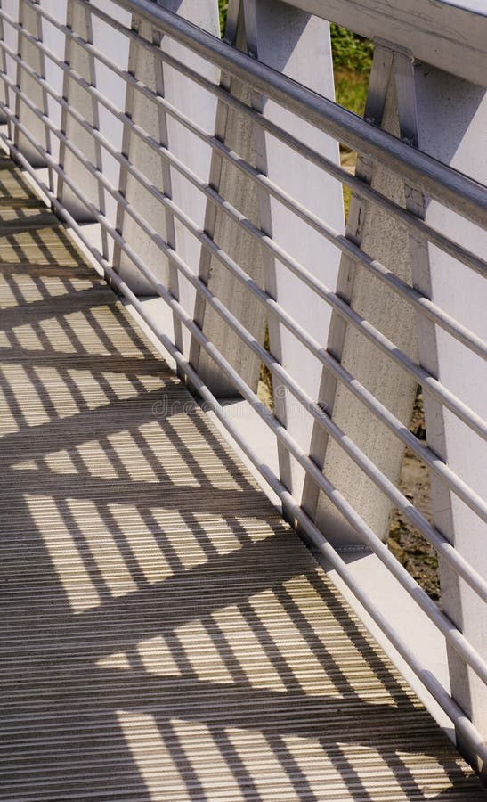 Shadows from Geometric Steel Railing on Bridge Stock Photo - Image of ...