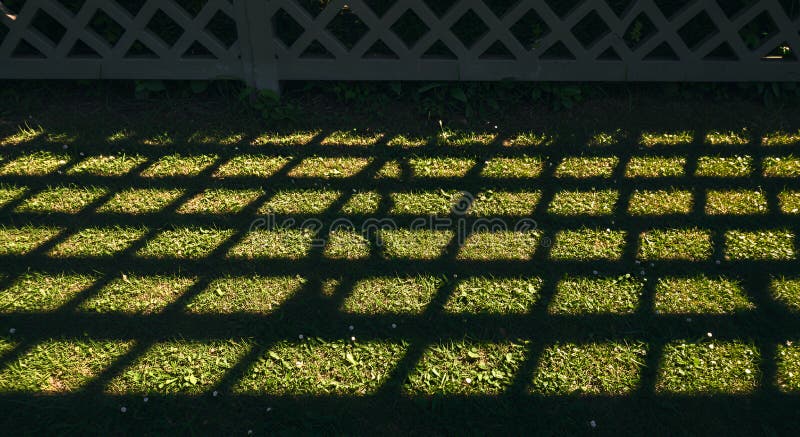 Shadows on Grass Creating a Grid Pattern from Wooden Structure Stock ...