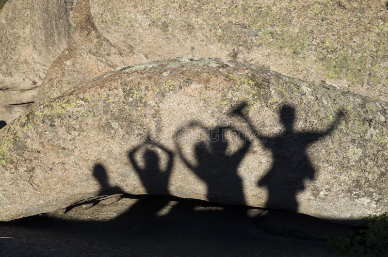 Shadows of Happy People with Arms Raised on Rock Stock Image - Image of ...