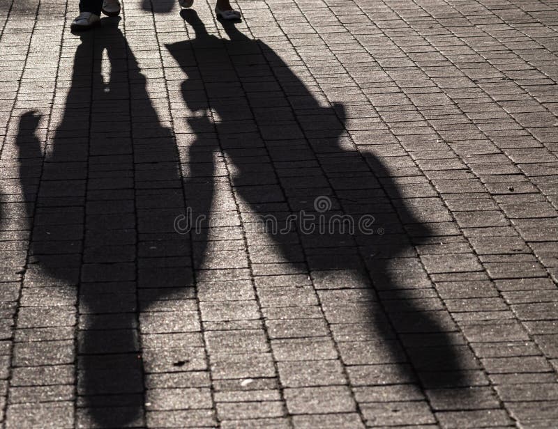 Shadows on Pavement of Two People Walking Under Bright Sunlight Stock ...