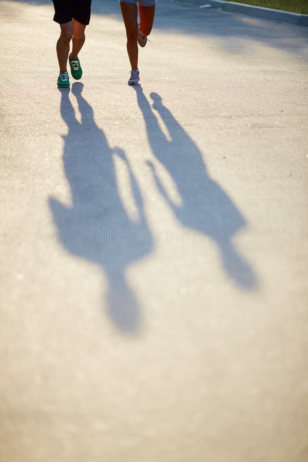 Shadows of runners stock photo. Image of road, footwear - 58243770