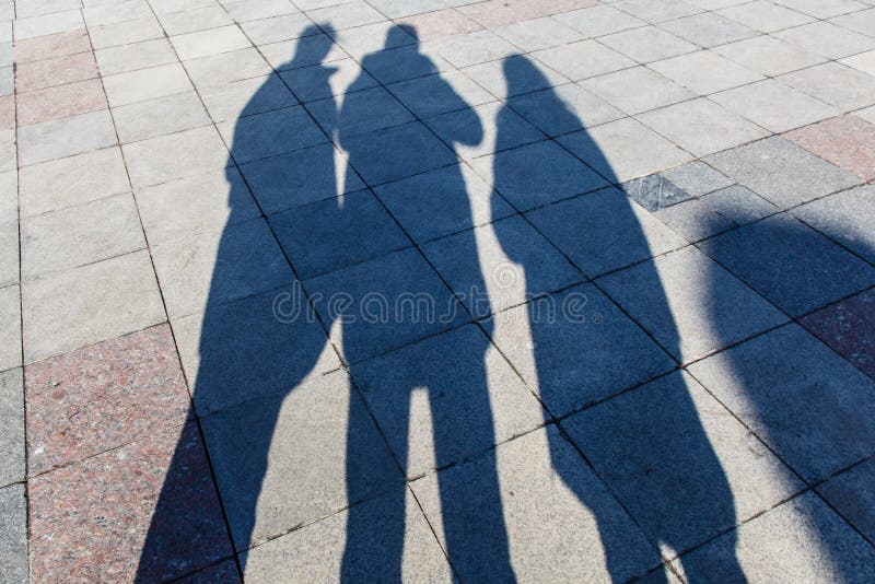 The Shadows of Three People on a Pavement Tiles Stock Image - Image of ...