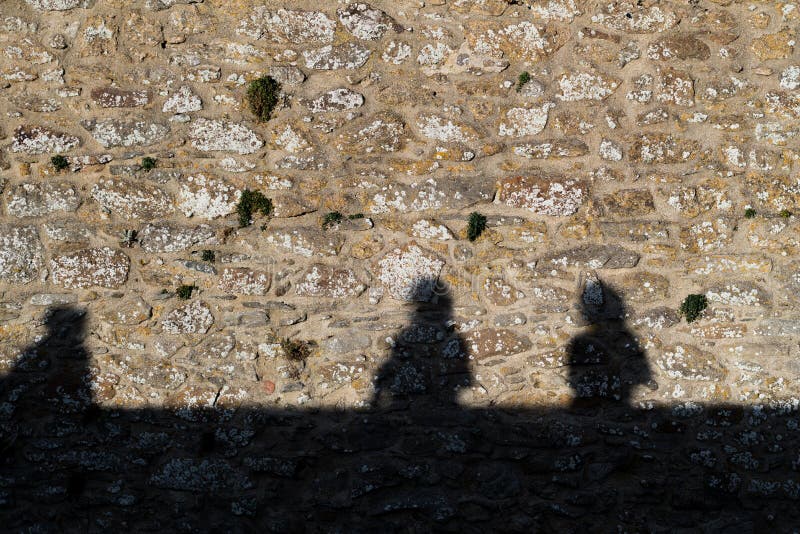 Shadows of Three People on a Stone Wall Stock Photo - Image of adult ...