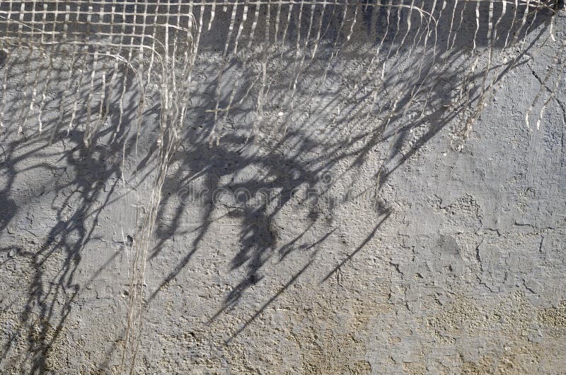 Shadows of Torn Fabric on Rough Uneven Wall. the Gray Exterior W Stock ...