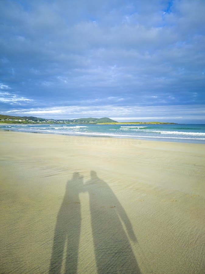 Shadows of Two Human Standing on the Sandy Beach Stock Image - Image of ...