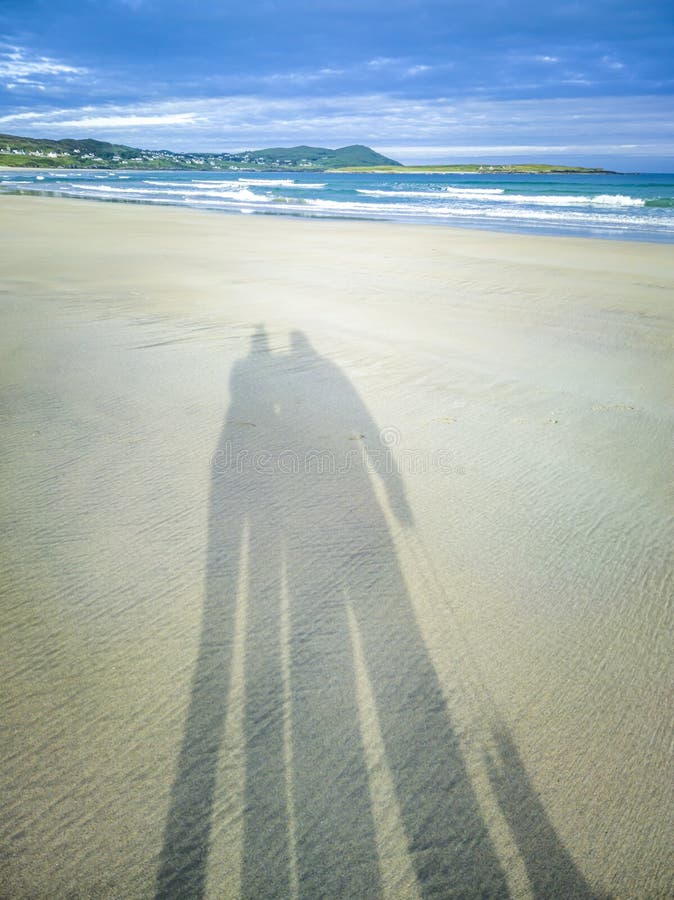Shadows of Two Human Standing on the Sandy Beach Stock Image - Image of ...