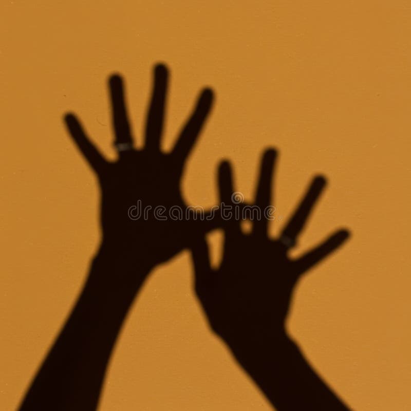 Shadowy Hands Silhouette with Rings on Orange Wall Stock Illustration ...