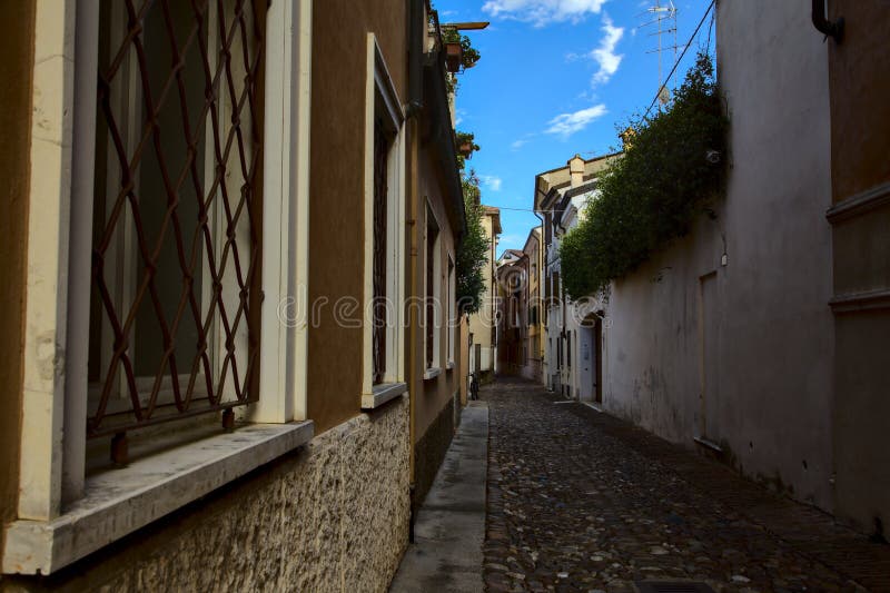 Shady Street in a European Town Bordered by Tall Buildings Stock Image ...