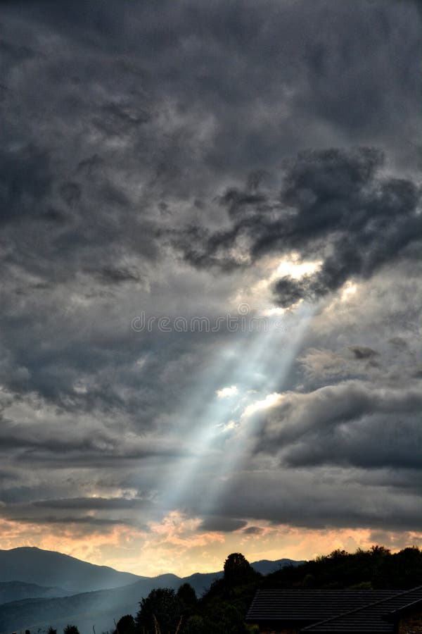 A Shaft of Light Rays Amidst a Storm Stock Image - Image of hole ...