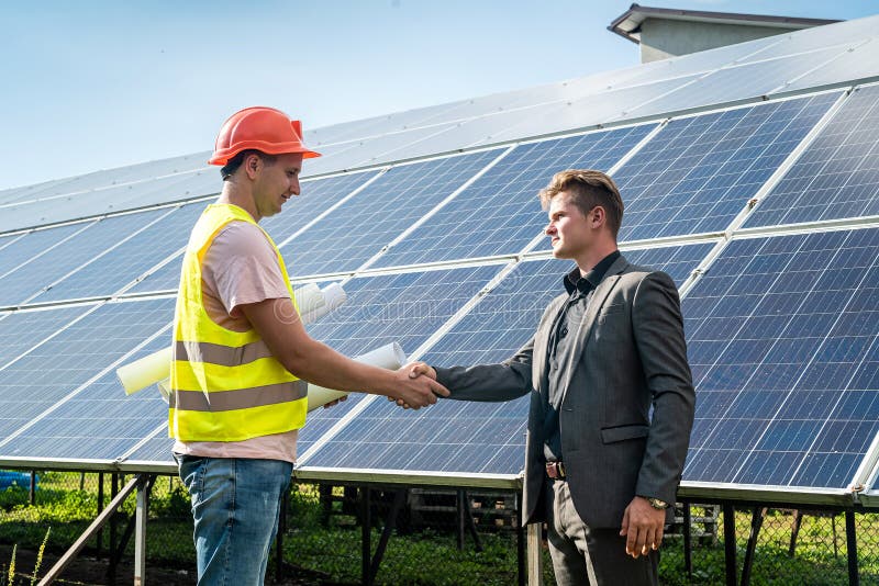 Shaking Hands Against Solar Panel after the Conclusion of the Agreement ...