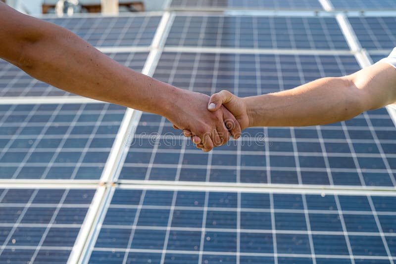 Shaking Hands Against Solar Panel after the Conclusion of the Agreement ...