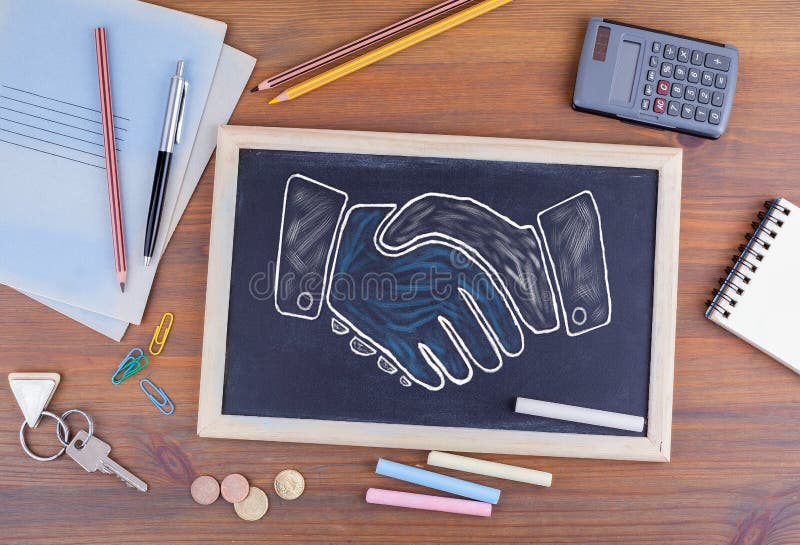 Shaking Hands. Chalkboard on Wooden Office Desk Stock Photo - Image of ...