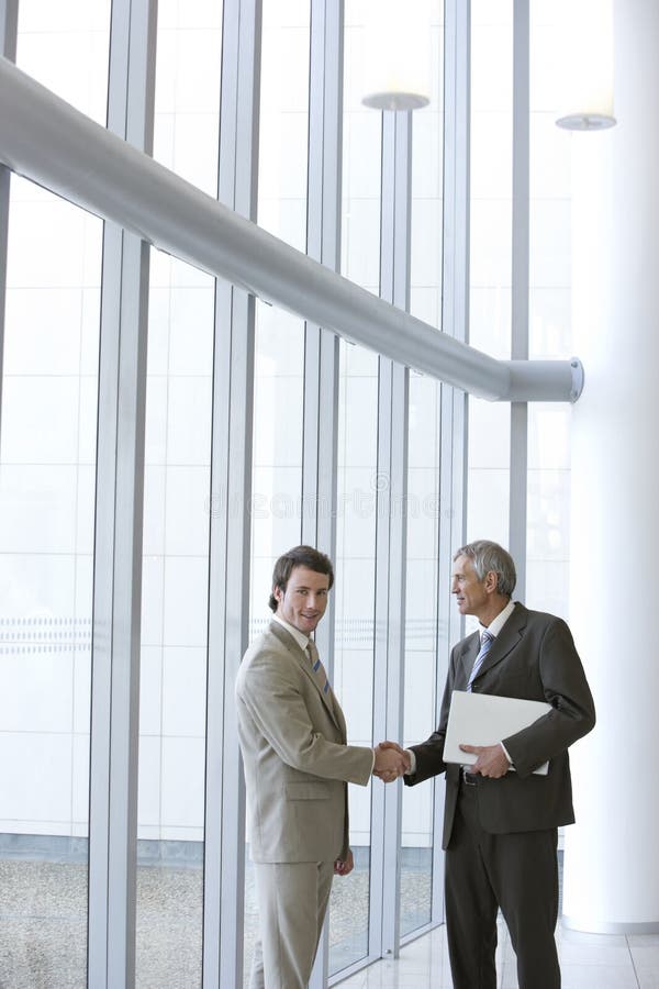 Shaking Hands in Front of Windows Stock Image - Image of recruitment ...