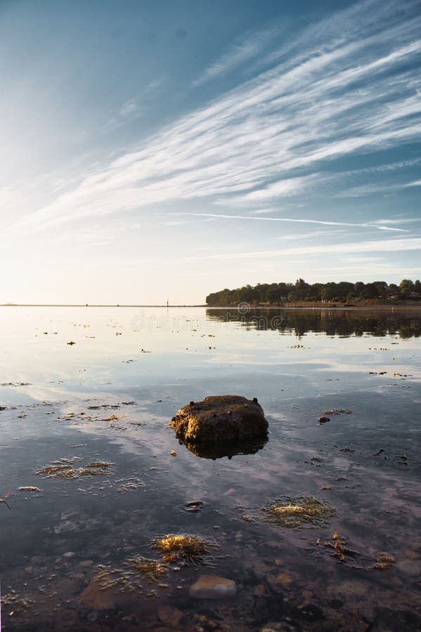 Shallow Beach with Mesmerizing Landscape and Cloudscape, Vertical Stock ...