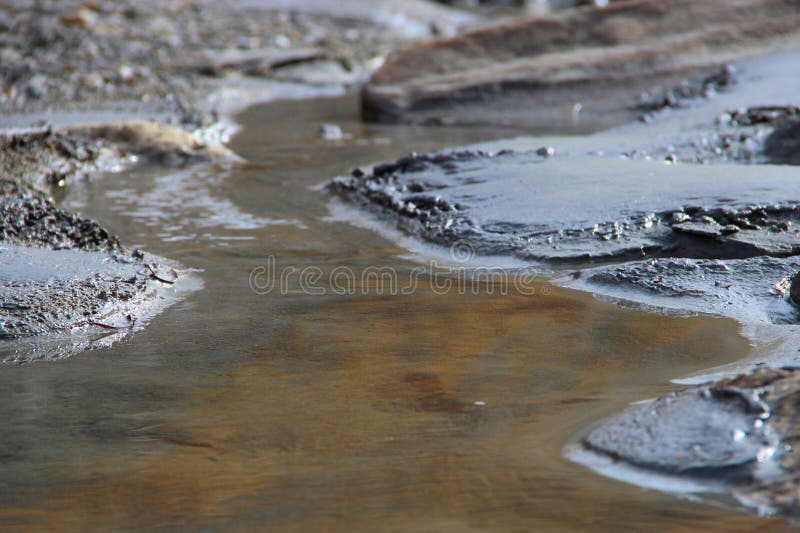 There is a Puddle of Mud in the Middle of the Water Stock Photo - Image ...