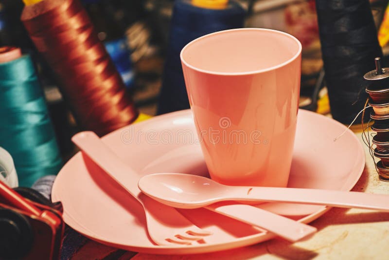 Pink Plastic Dinnerware Set in Tailor Sewing Workshop.Cup,fork,knife ...