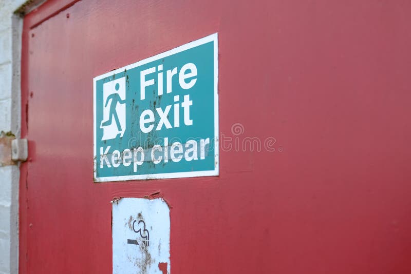 Shallow Focus of an Old Fire Exit Sign and Door Located at a Warehouse ...