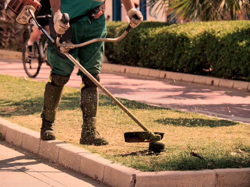 Shallow Focus of a Person Cutting Grass with a Lawnmower Pit Stock ...