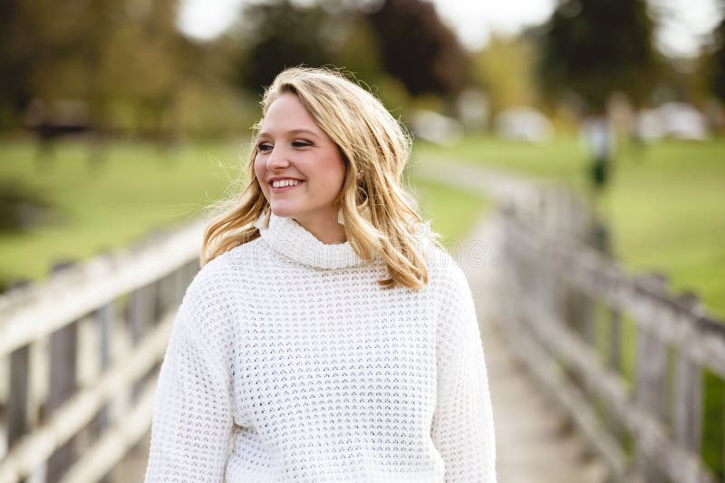Shallow Focus Shot of a Beautiful Female Wearing a White Sweater and ... Shallow Focus Shot of a Beautiful Female Wearing a White Sweater and ...