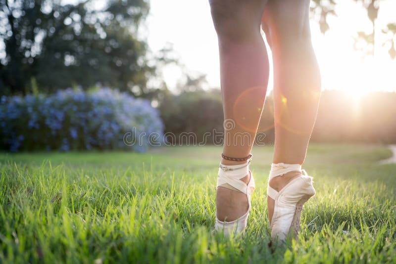 Shallow Focus Shot of the Feet of a Ballet Dancer Standing on the Green ...