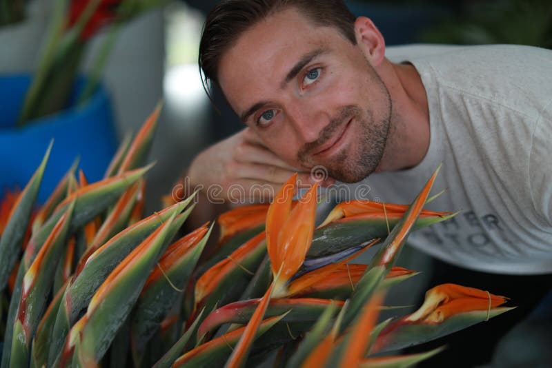 Shallow Focus Shot of a Male Smiling Near Flowers Stock Image - Image ... Shallow Focus Shot of a Male Smiling Near Flowers Stock Image - Image ...
