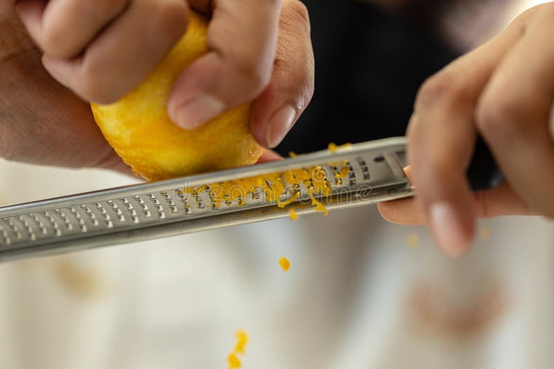 Shallow Focus Shot of a Person Grating a Fruit on a Grater Stock Image ...