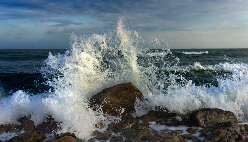 Shallow Focus Shot of the Waves Hitting the Rocks Stock Photo - Image ...
